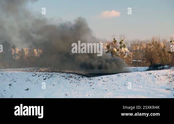 Crematorium smoke rising over a snowy cemetery, symbolizing death ...