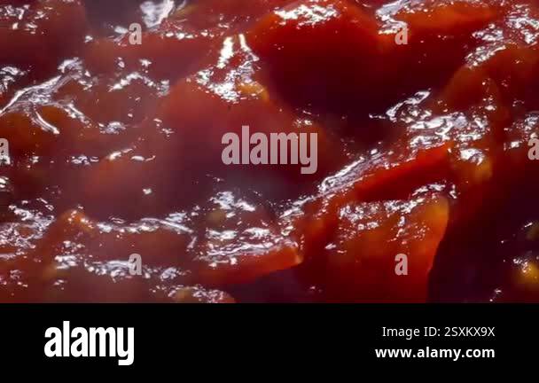 Rich, slow-cooked tomato sauce with a vibrant red hue and a hearty ...