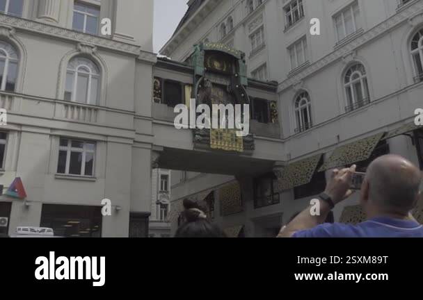 August 26, 2024. Vienna, Austria. crowd of people peering up Ankeruhr ...