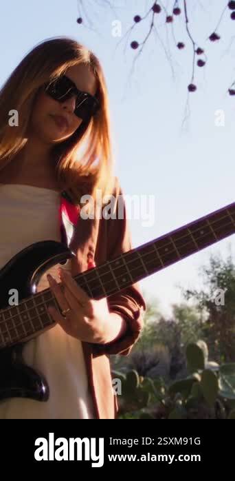 Girl playing bass guitar in the nature near the beach Stock Video ...