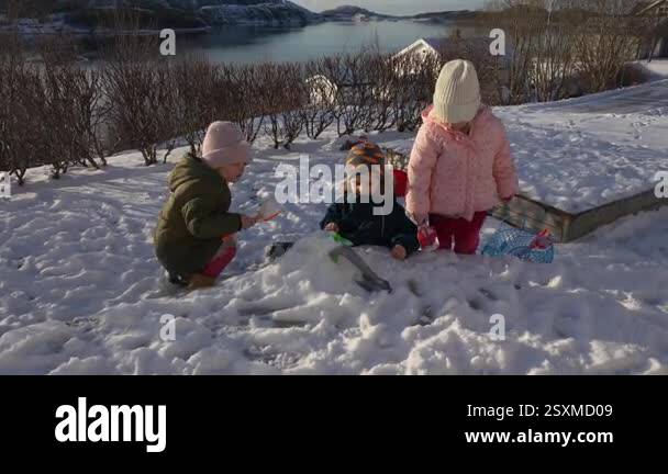 Joyful preschool children play in the snow, enjoying winter fun in ...