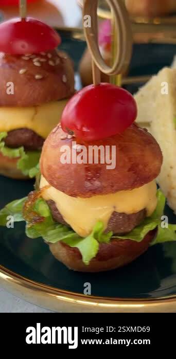 A tray of delicious Beef Sliders is served at a restaurant as a male ...