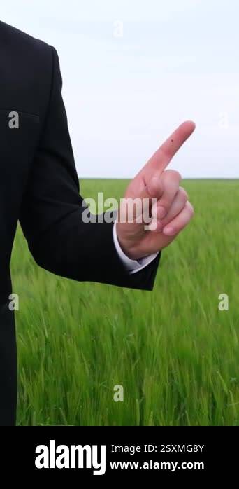 A businessman confidently gestures with a raised finger, while standing ...