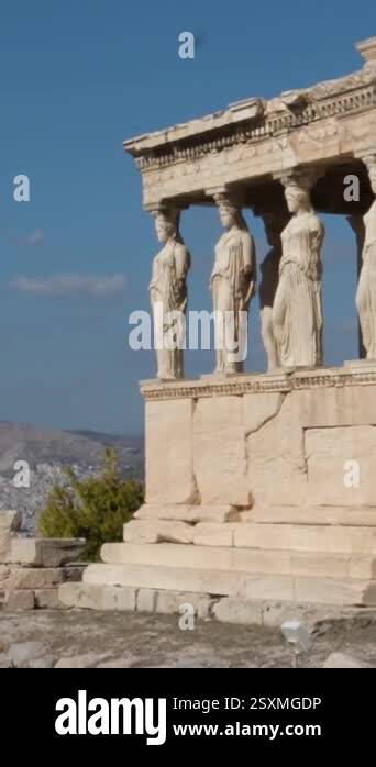 Ancient Erechtheion temple with pillars and statues on Acropolis hill in Athens, Greece. Athens ...