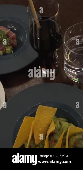 Mexican guacamole and tortilla chips, nachos, top view of slowly ...
