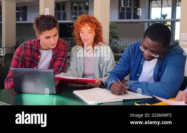 Three enthusiastic students collaborating together on academic projects while sharing ideas and ...