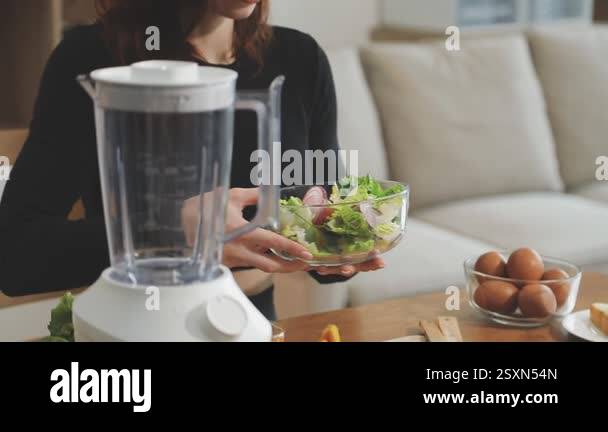 woman preparing fresh smoothie in kitchen Stock Video Footage - Alamy