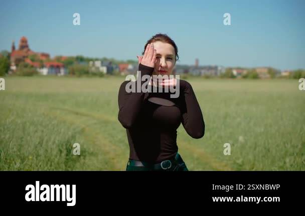 Female dancing with expressive hand and face movements, highlighting ...