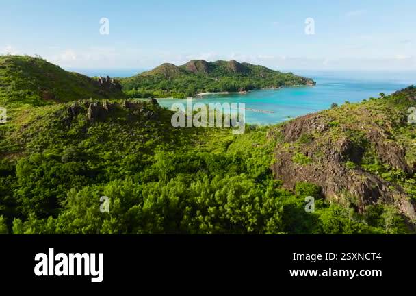 A scenic view of verdant hills and rugged cliffs surrounding a calm ...