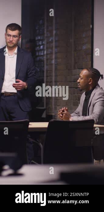 Vertical Screen: Diverse business team discussing artificial ...