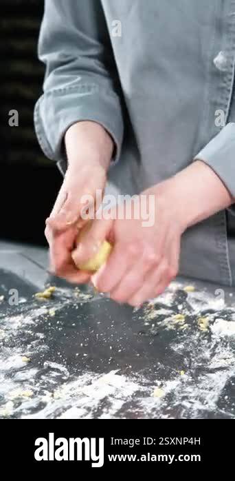 A detailed closeup image showcases hands skillfully kneading dough on a ...
