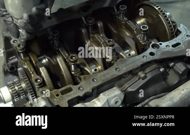 Engine repair. Auto mechanic working on car engine in mechanics garage ...