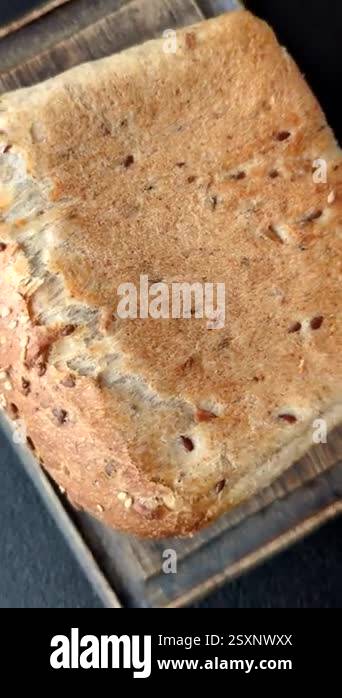 Brown bread with grains and seeds on a dark concrete background Stock ...