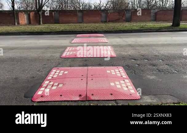 Speed bump on the road to slow down fast moving cars. Rubber Berlin ...