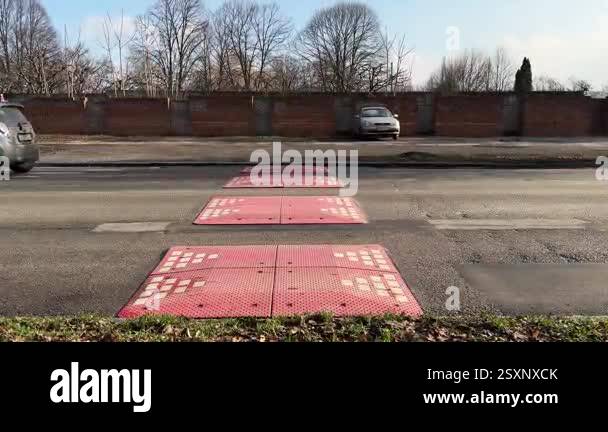 Speed bump on the road to slow down fast moving cars. Rubber Berlin ...