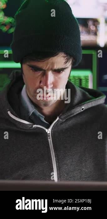 Vertical HD video of young hacker man concentrating on breaking into ...