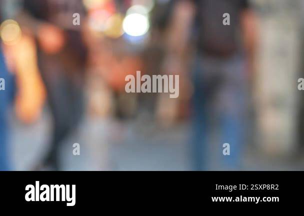 People walk through a lively street filled with activity and color ...
