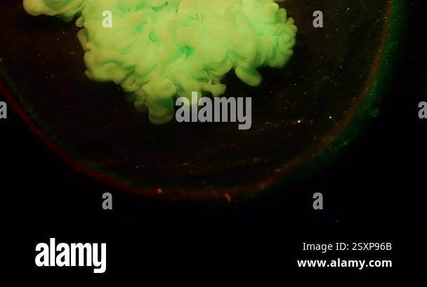 Haze flow. Hypnotic fluid. Yellow green art mix neon paint spilling on ...