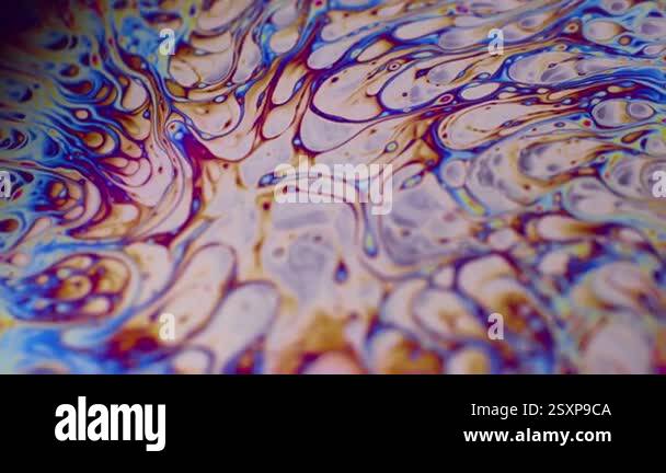 Iridescent fluid. Bubble art. Defocused multicolor purple green liquid ...