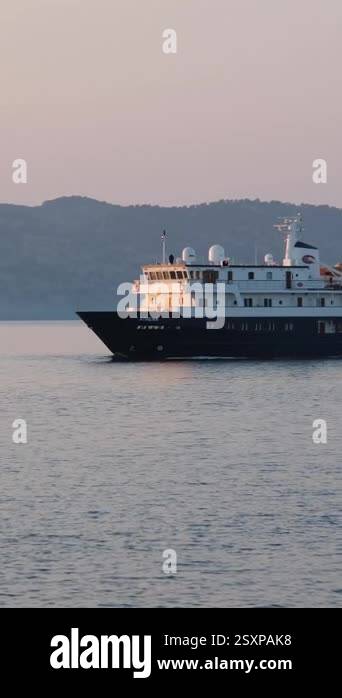 Aerial front tracking view of a generic cruise ship saling over the ...