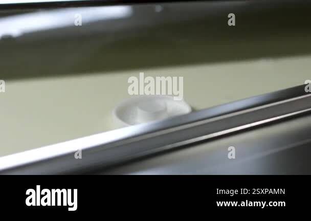 hands of skilled unrecognizable female factory worker in rubber gloves ...