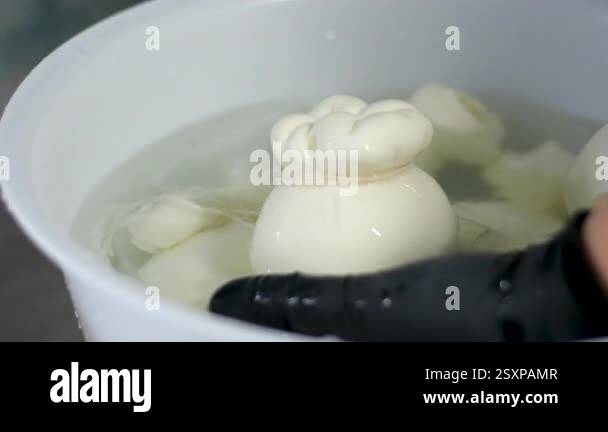 hands of skilled unrecognizable female factory worker in rubber gloves ...