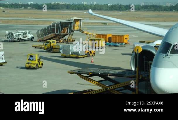 Qatar Airways loading luggage airplane airport runway people working at ...