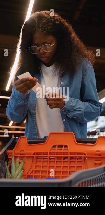 Young African American homemaker wearing glasses and a denim shirt ...