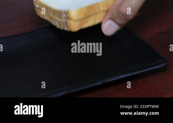Plating bread and sliced boiled egg to serve in a black plate Stock ...