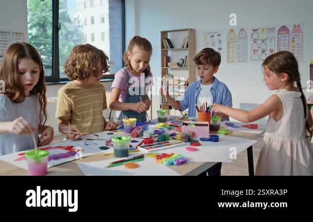 Pupils creating colorful art at collaborative workshop with vibrant ...