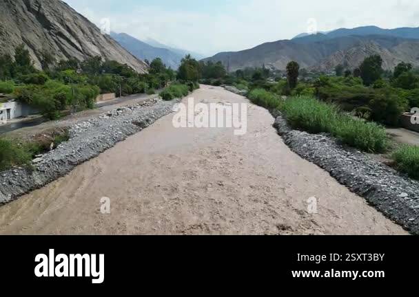 Powerful and muddy river surge after a huayco (landslide) in South ...