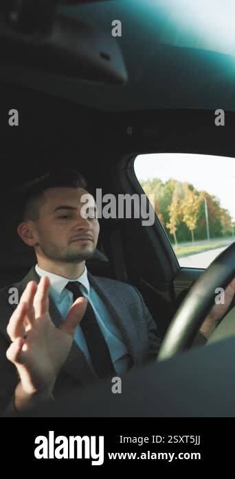 Vertical Video of Man driving in innovative automated car using self ...