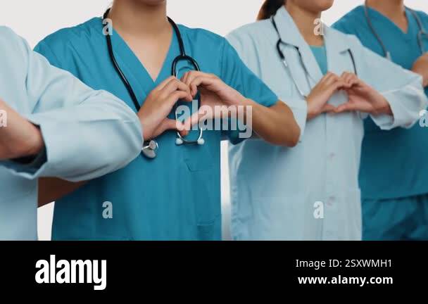 Professional team of medical staff stand in line, raise heart hand ...