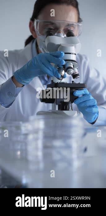 Woman scientist wearing blue gloves, protective glasses and medical ...