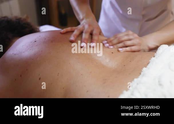 Obese middle-aged woman receives a special body massage intended for ...