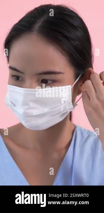 Young Asian woman take off face mask removing from face showing concept ...