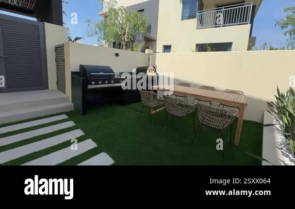 Barbecue in the backyard of a wealthy private villa in Dubai. Outside ...