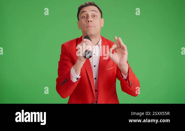 Energetic tv host introduces a performer, using a microphone and ...