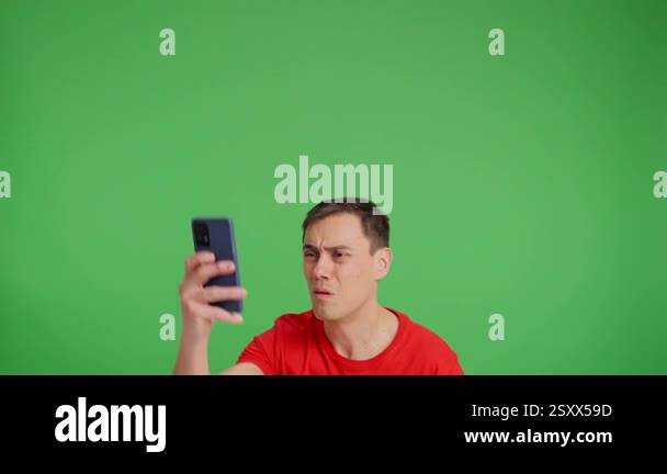 Frustrated man in red t shirt trying to find mobile network coverage ...