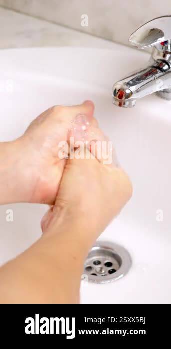 Man carefully washes his hands with soap and water in bathroom sink Stock Video Footage - Alamy