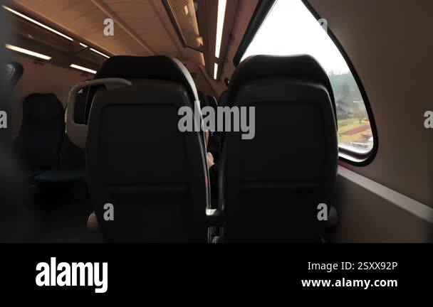 Back view of seats and windows in a modern double decker train with ...