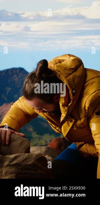 Vertical Video Proud explorer celebrates on top of a high altitude ...