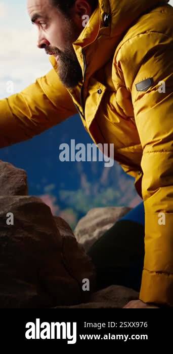 Vertical Video Nature lover on a mountain peak breathes in the crisp ...