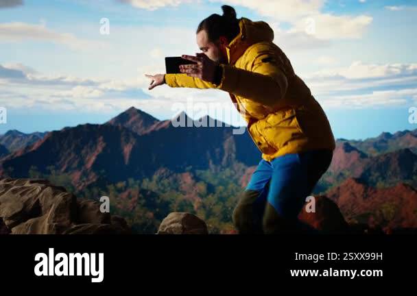 Reckless adventurer losing balance to take a picture and dropping phone ...