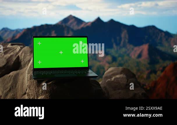 Remote wilderness escape featuring rocky peaks with green screen and ...