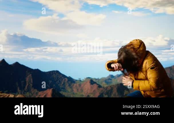 Clumsy traveler loses balance on a steep mountain peak as powerful ...