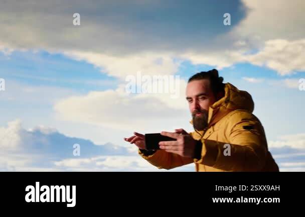 Reckless adventurer losing balance to take a picture and dropping phone ...