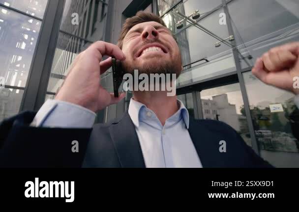 Happy rejoice joyful amazed excited smartphone call male close up ...