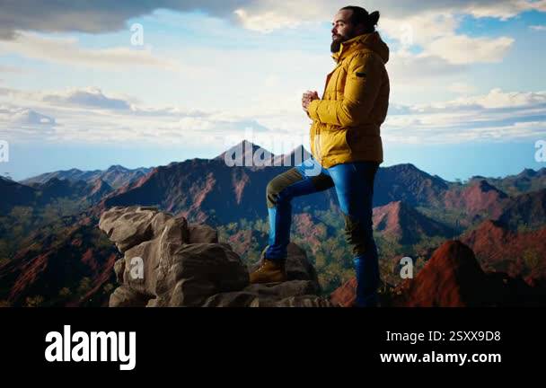 Traveler stands alone in the high altitude wilderness admiring the ...