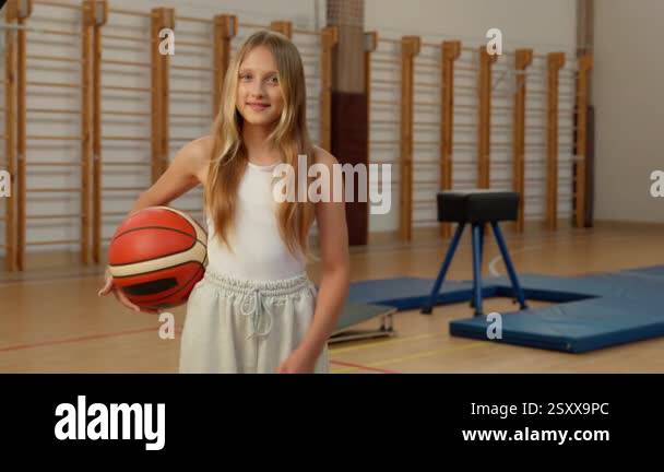 Caucasian child little girl throwing basketball ball showing thumb up ...